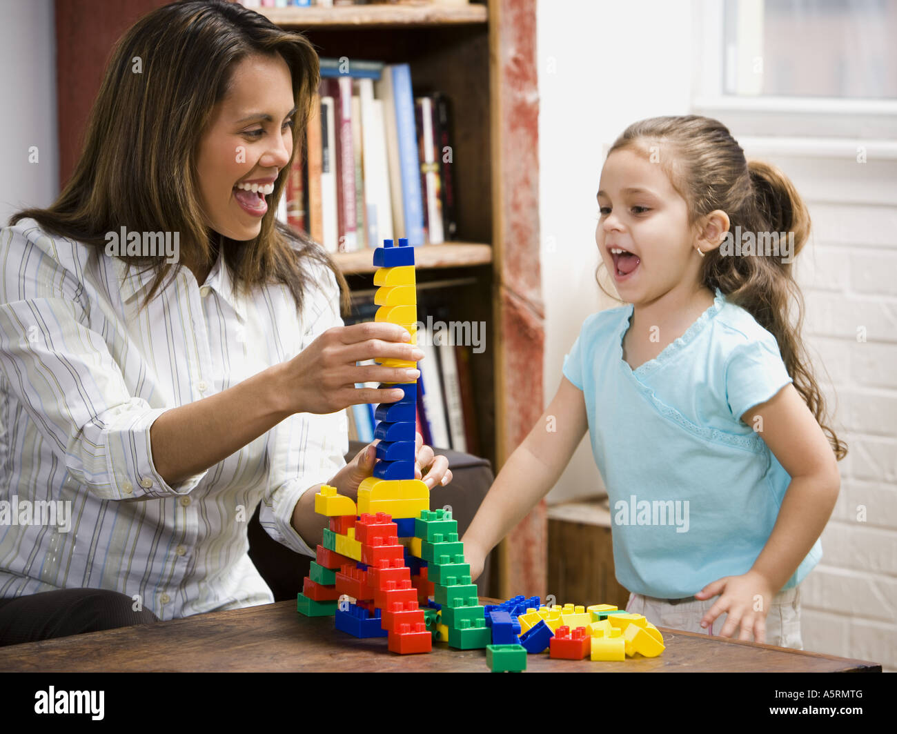 Mother and young daughter playing with building blocks Stock Photo - Alamy