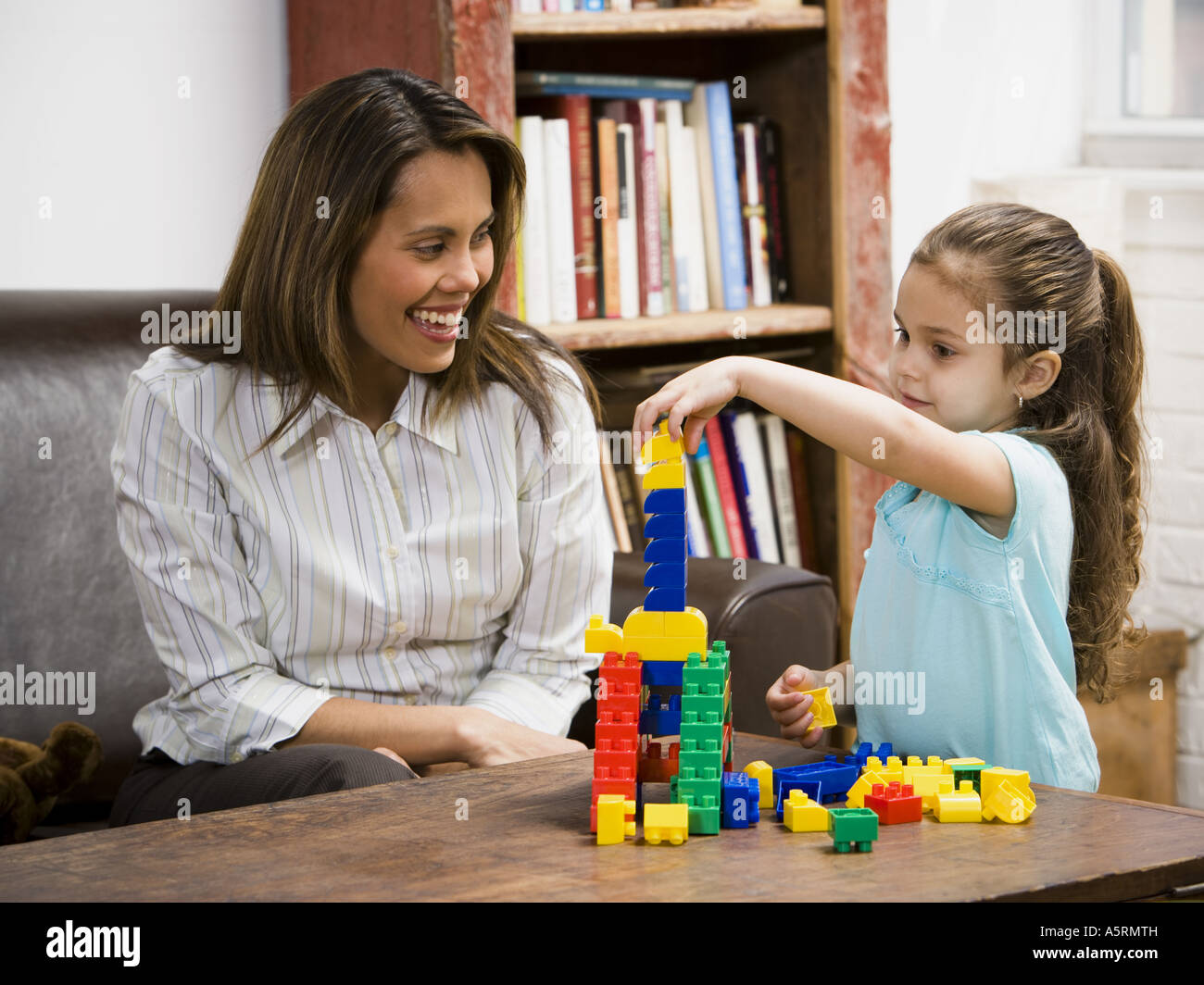 Mother and young daughter playing with building blocks Stock Photo - Alamy