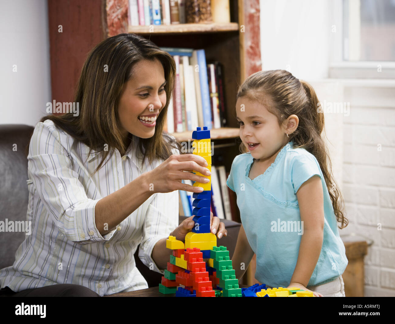 Mother and young daughter playing with building blocks Stock Photo - Alamy