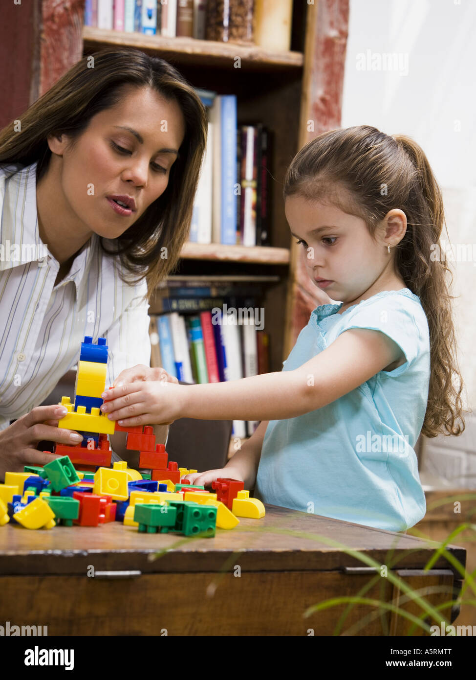 Mother and young daughter playing with building blocks Stock Photo - Alamy