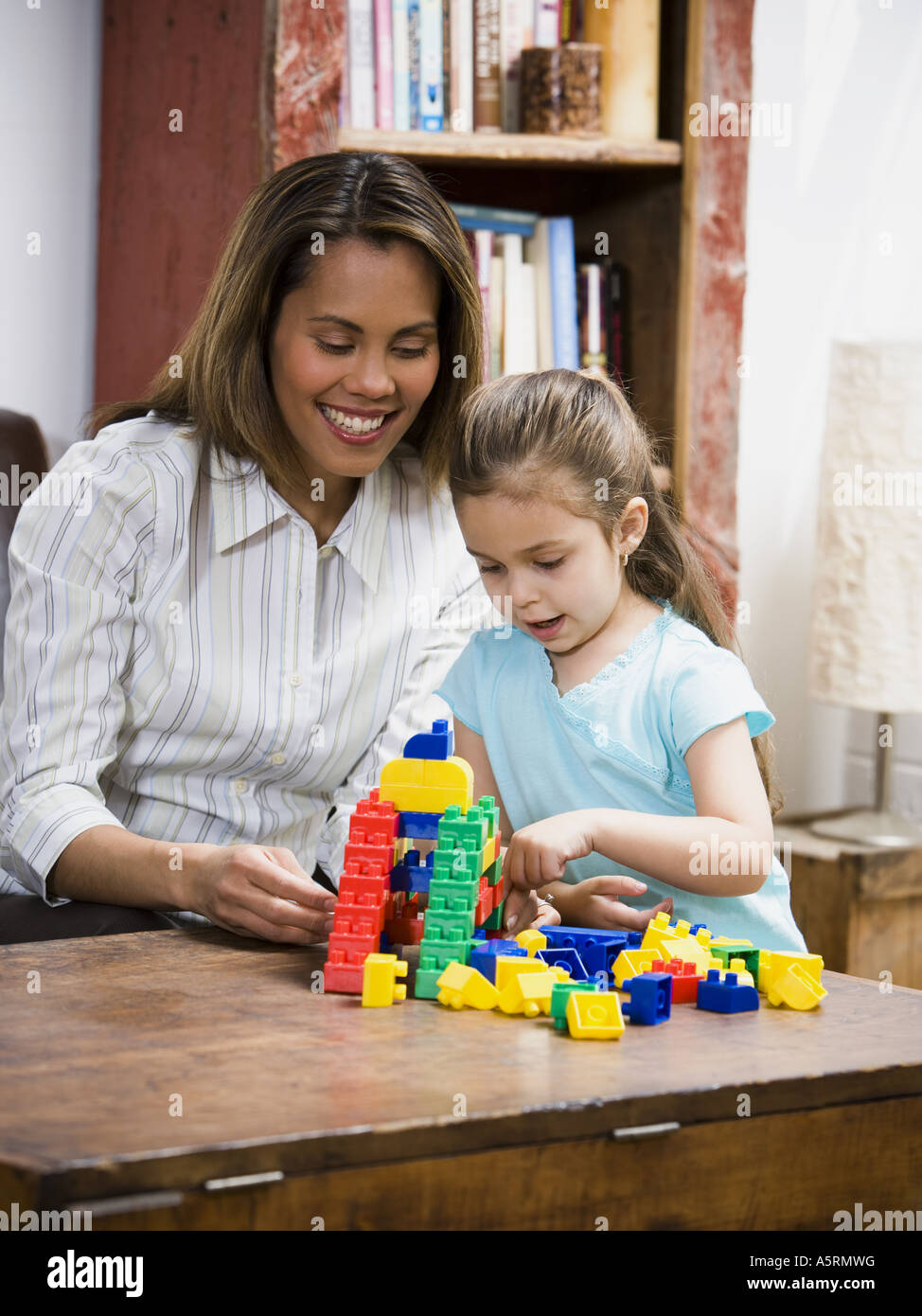 Mother and young daughter playing with building blocks Stock Photo - Alamy