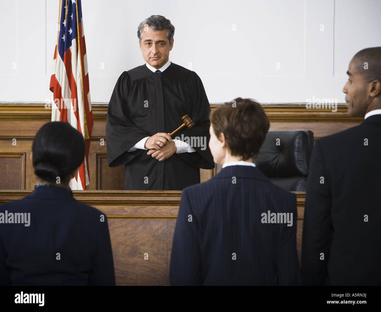 Judge standing in front of defendants and lawyers Stock Photo - Alamy
