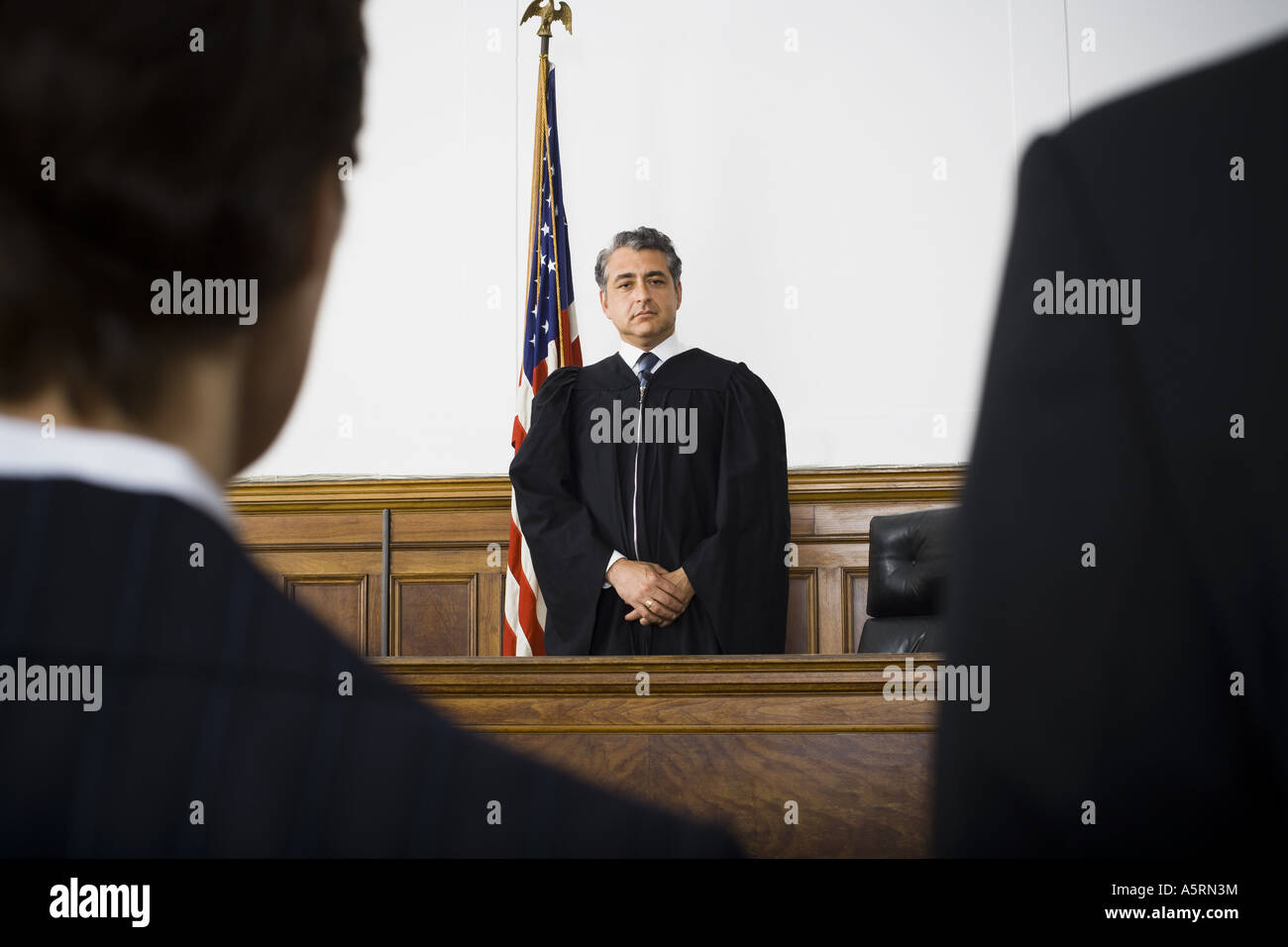 Judge standing in front of defendants and lawyers Stock Photo - Alamy