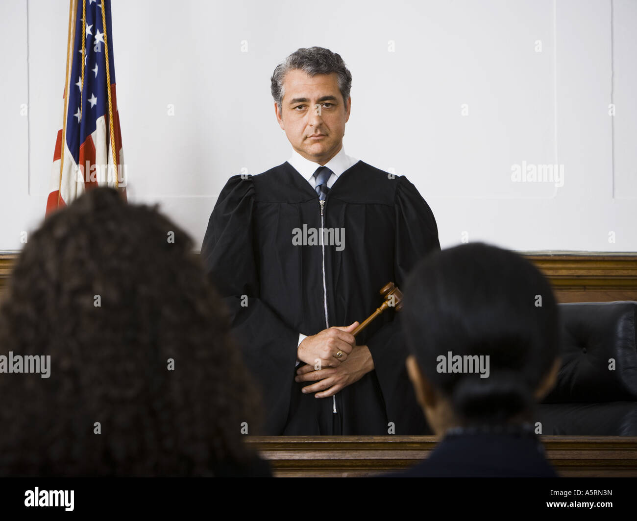 Judge standing in front of defendants and lawyers Stock Photo - Alamy