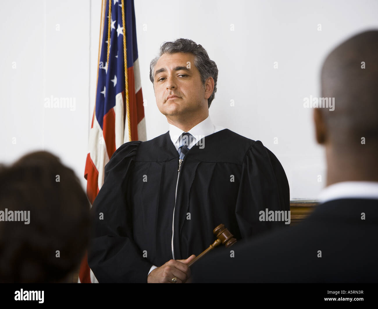 Judge standing in front of defendants and lawyers Stock Photo - Alamy