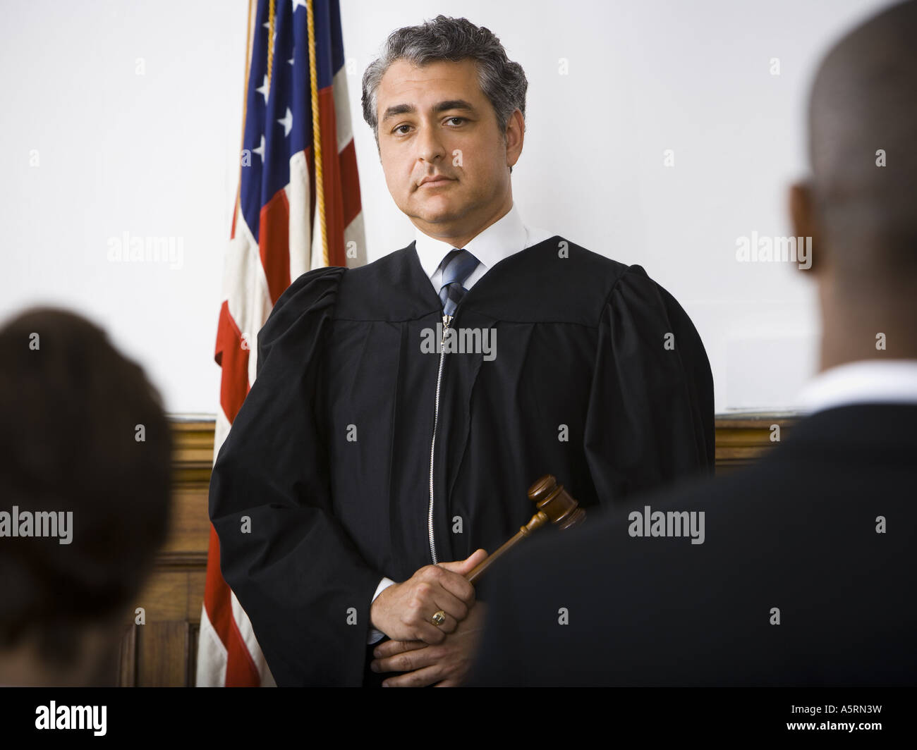 Judge standing in front of defendants and lawyers Stock Photo - Alamy