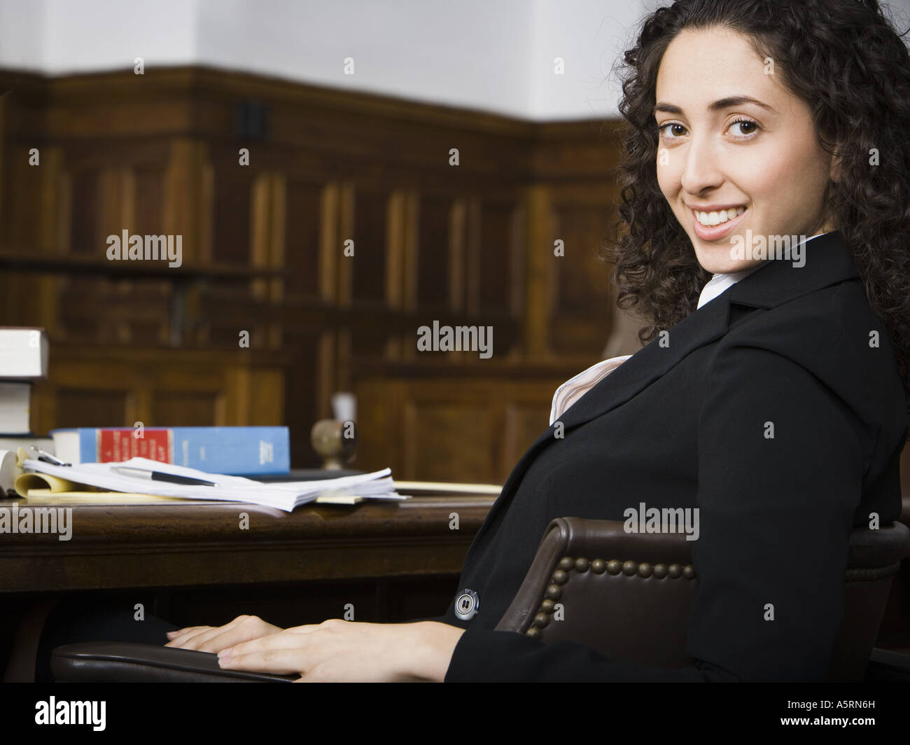 Female lawyer smiling in courtroom Stock Photo - Alamy