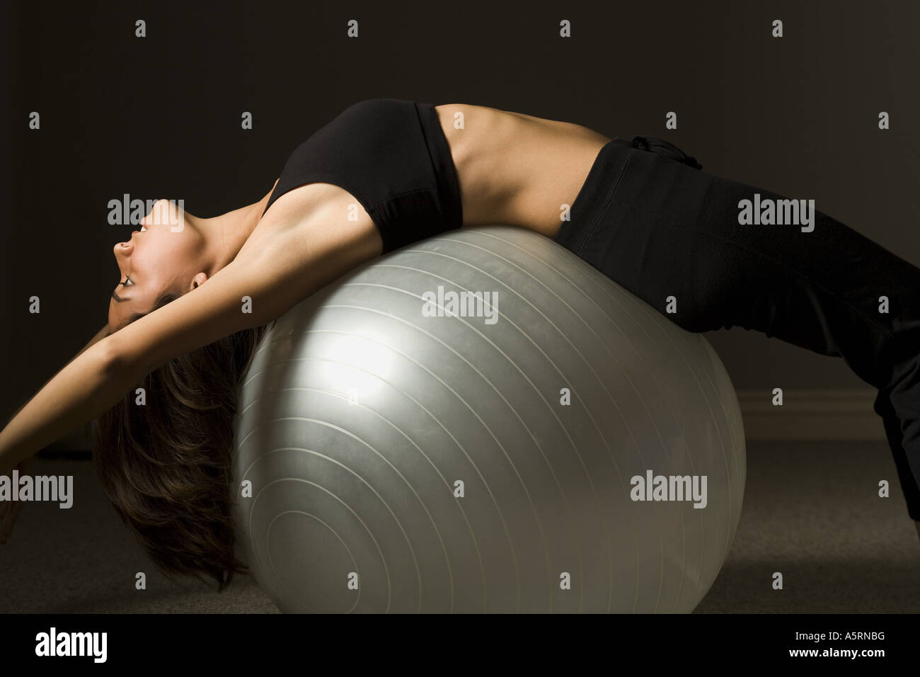 Woman performing Pilates exercises Stock Photo - Alamy