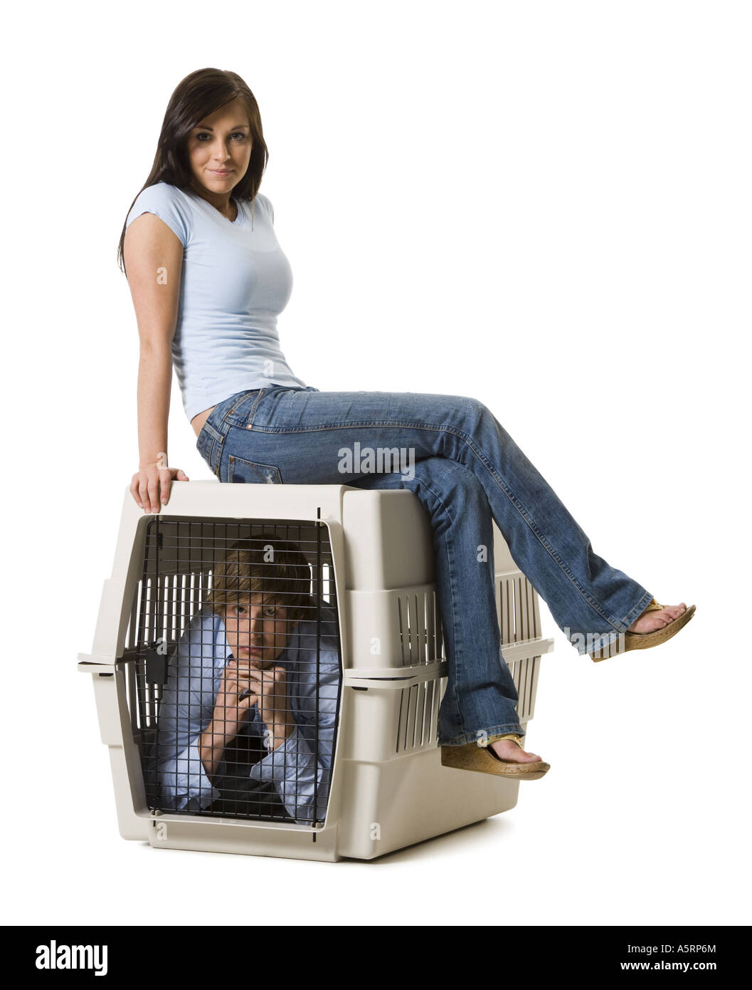 Young woman sitting on crate with boyfriend inside Stock Photo - Alamy