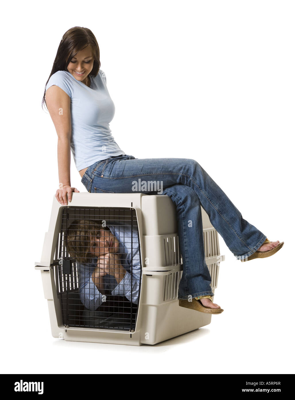 Young woman sitting on crate with boyfriend inside Stock Photo - Alamy