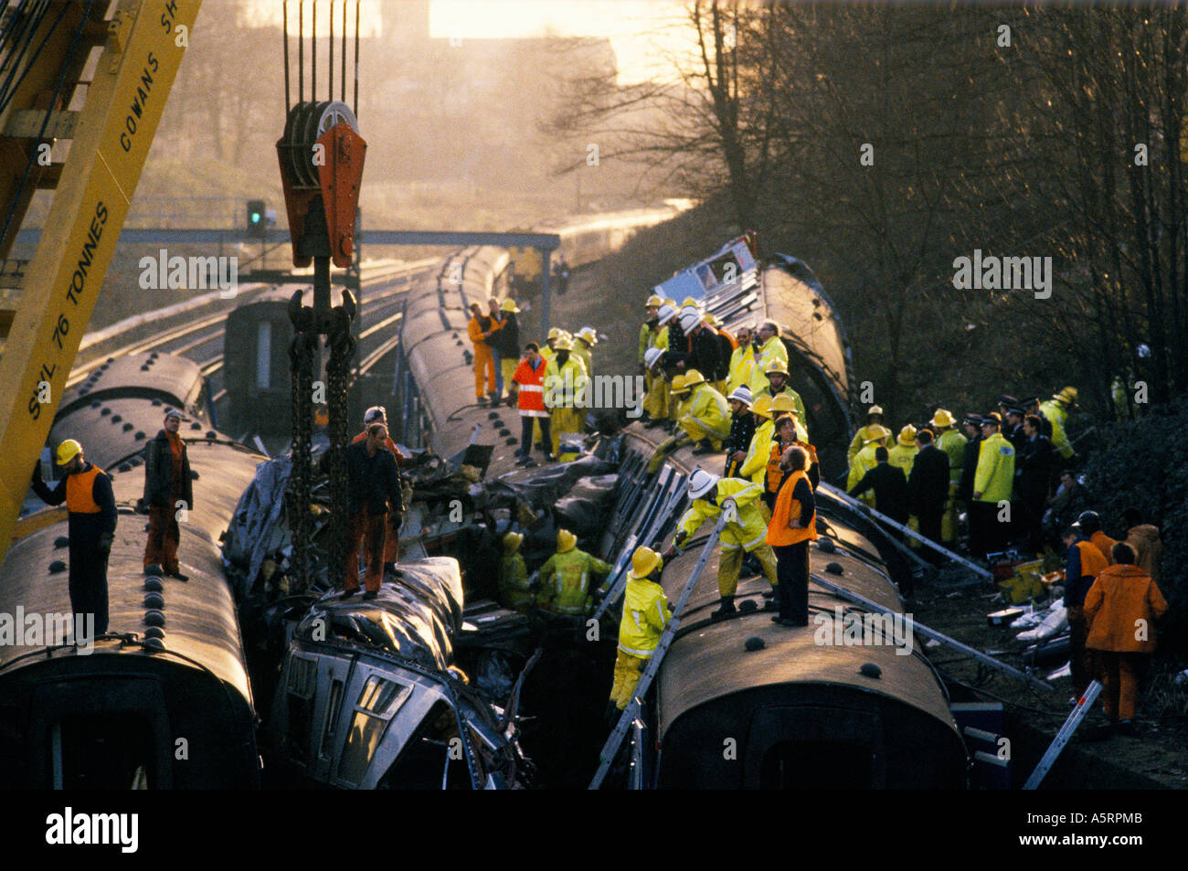 RESCUE WORKERS FIREMEN USING CRANE TO LIFT WRECKAGE OF CARRIAGES AT ...