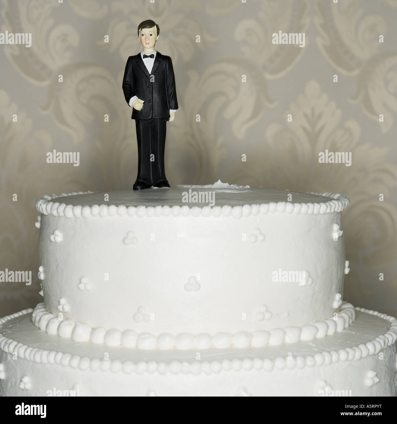 Wedding cake visual metaphor with figurine cake toppers Stock Photo - Alamy