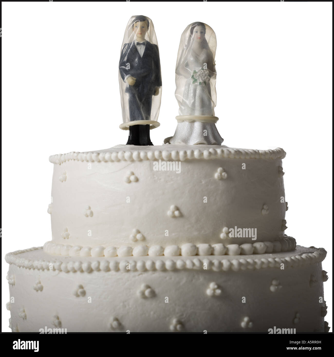 Wedding cake visual metaphor with figurine cake toppers Stock Photo - Alamy