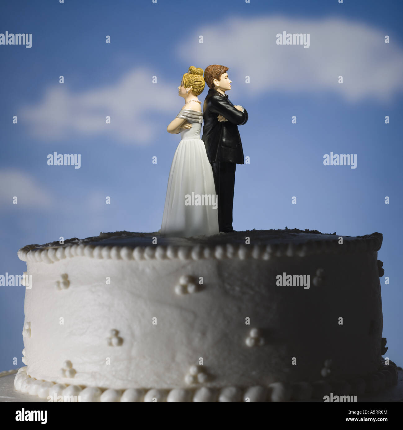 Wedding cake visual metaphor with figurine cake toppers Stock Photo - Alamy