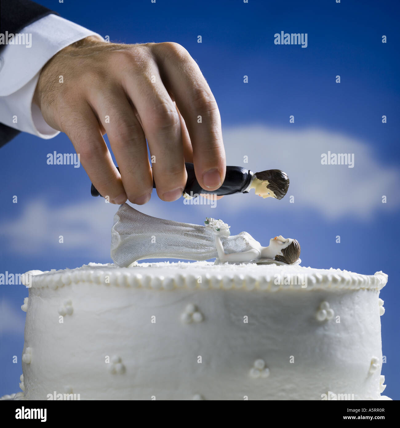 Wedding cake visual metaphor with figurine cake toppers Stock Photo - Alamy