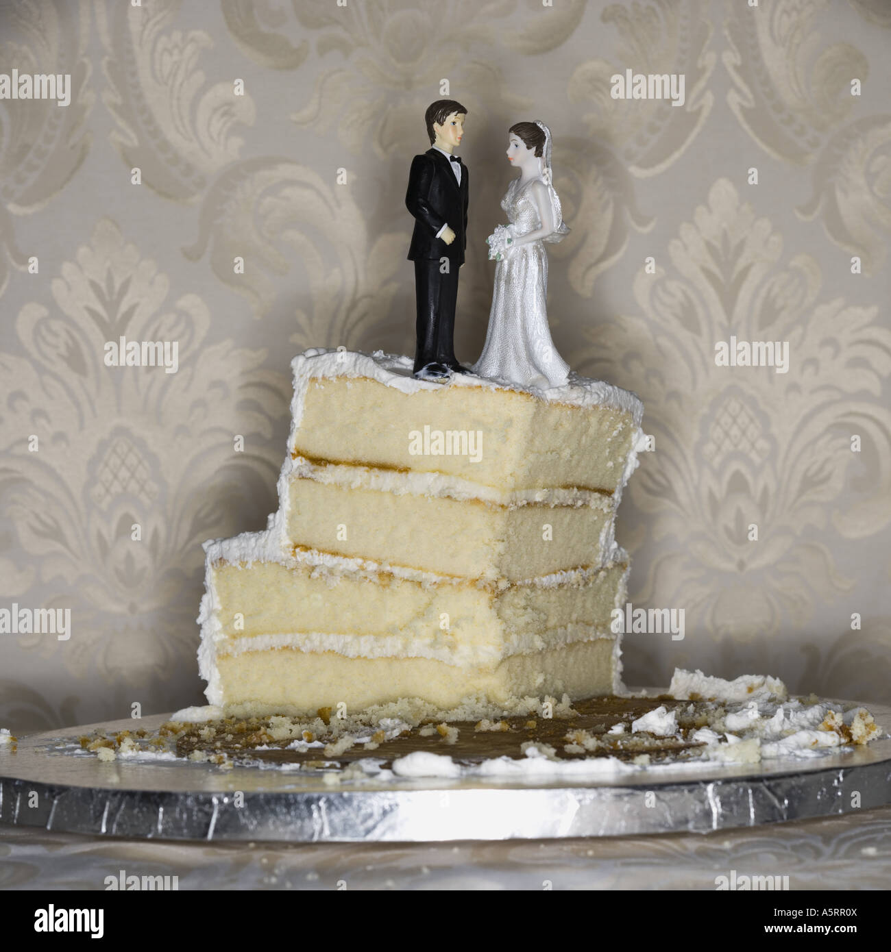 Wedding cake visual metaphor with figurine cake toppers Stock Photo - Alamy