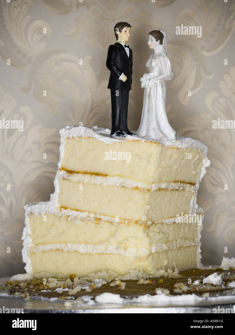 Wedding cake visual metaphor with figurine cake toppers Stock Photo - Alamy