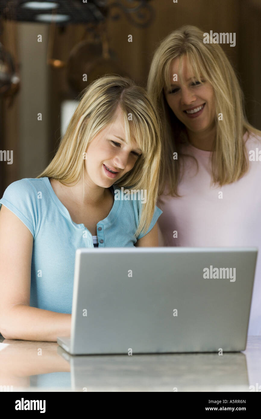 Young woman and mother working on laptop computer Stock Photo - Alamy