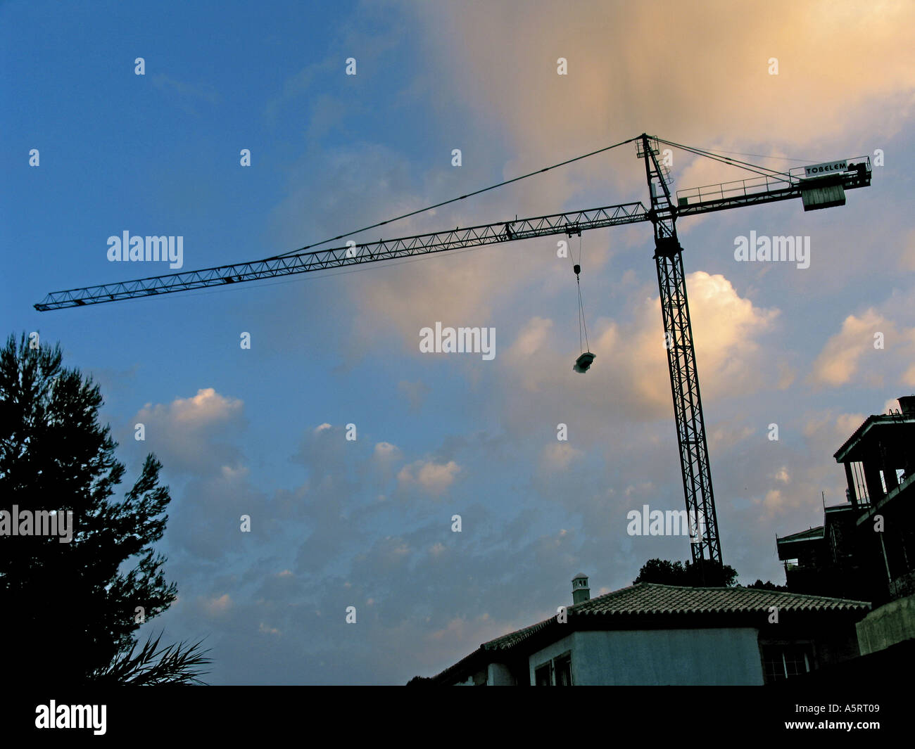 Crane above building under construction Stock Photo - Alamy