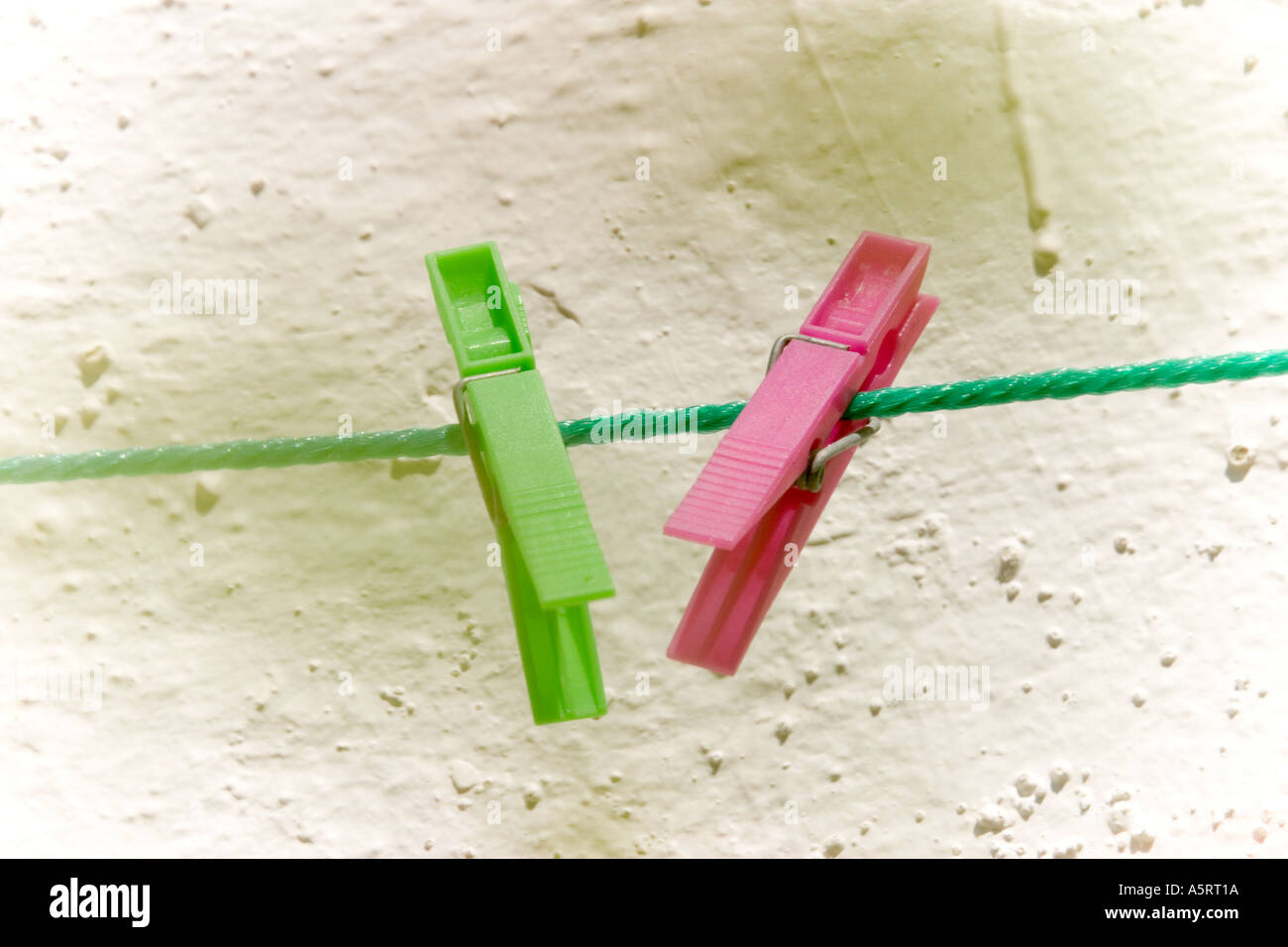 Two pegs on washing line Stock Photo - Alamy