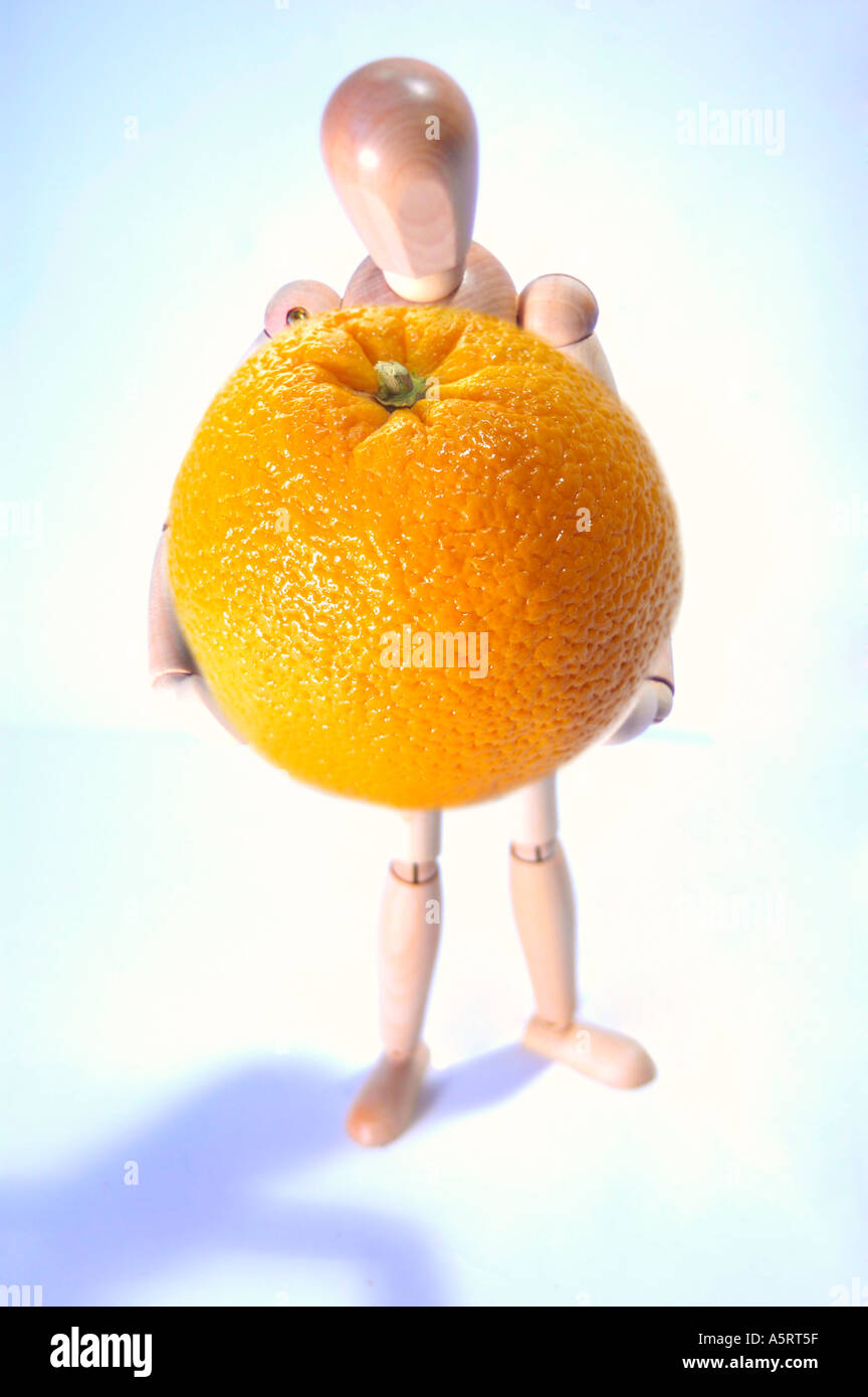Wood Puppet with a big Orange Stock Photo - Alamy