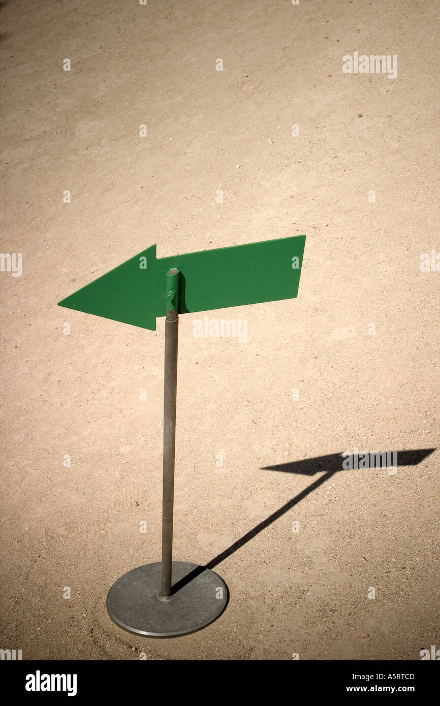 Green arrow on stand Stock Photo - Alamy