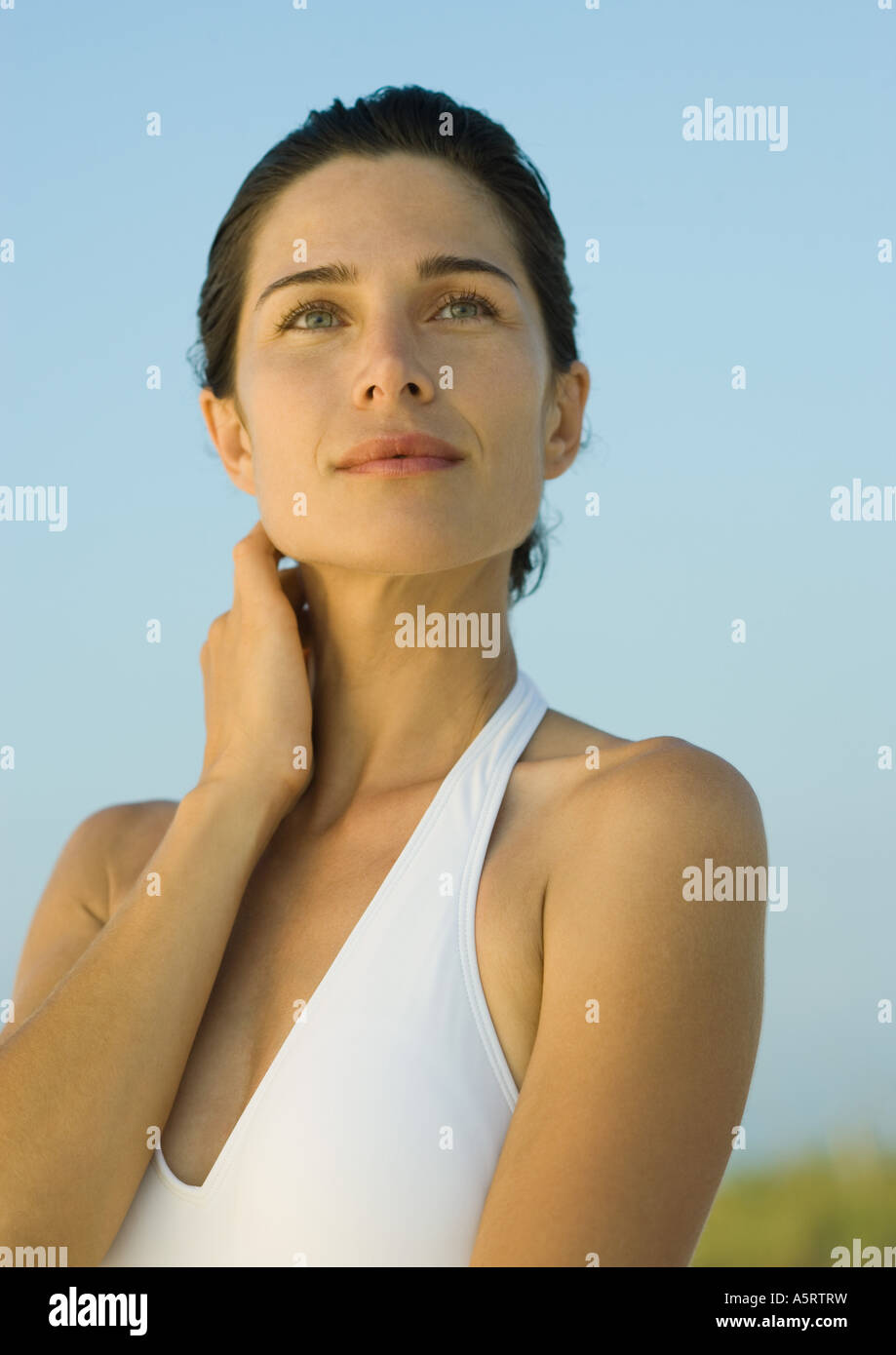 Woman with hand on neck, portrait Stock Photo - Alamy