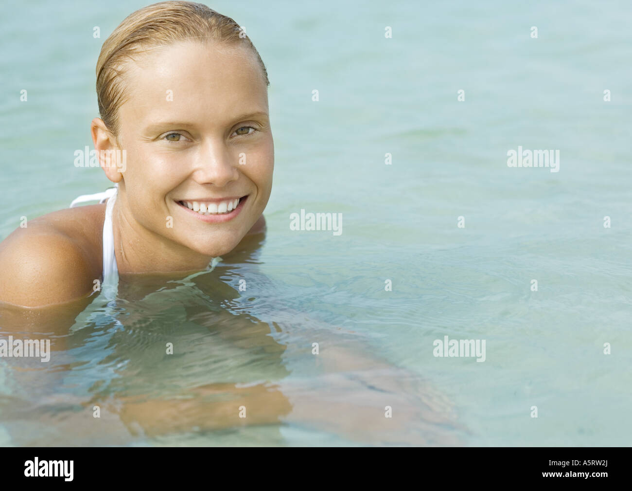 Woman in water, smiling at camera Stock Photo - Alamy