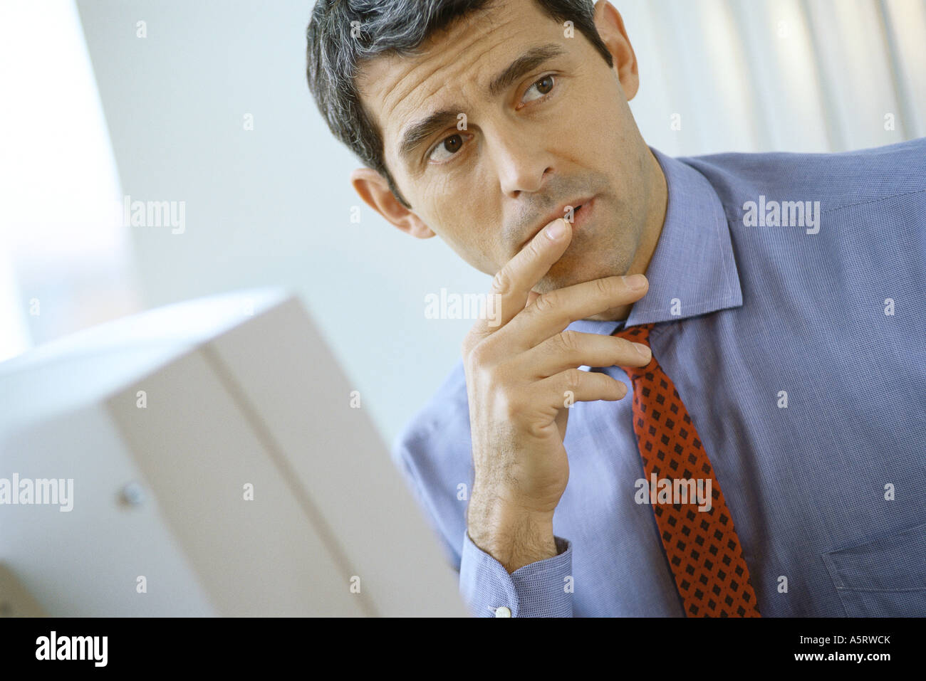 Businessman sitting computer finger lip hi-res stock photography and ...
