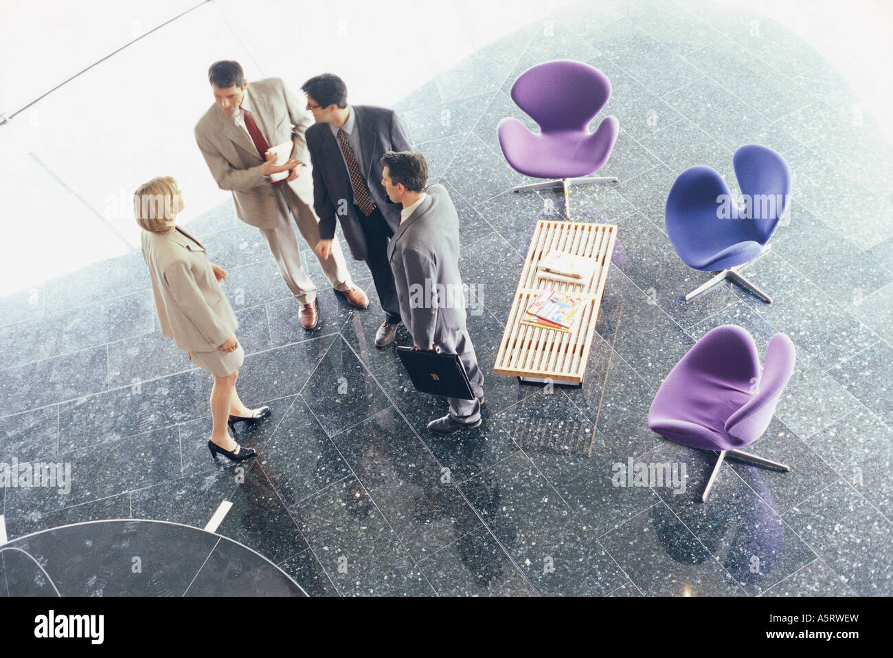 Office workers talking in lobby hi-res stock photography and images - Alamy