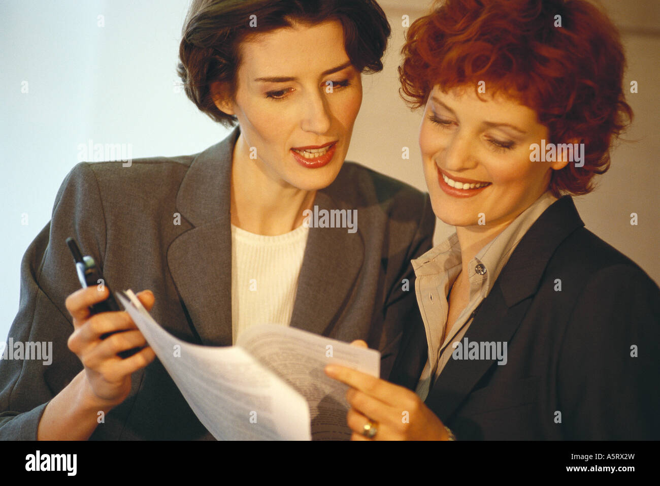 Standing looking down reading communication document hi-res stock ...