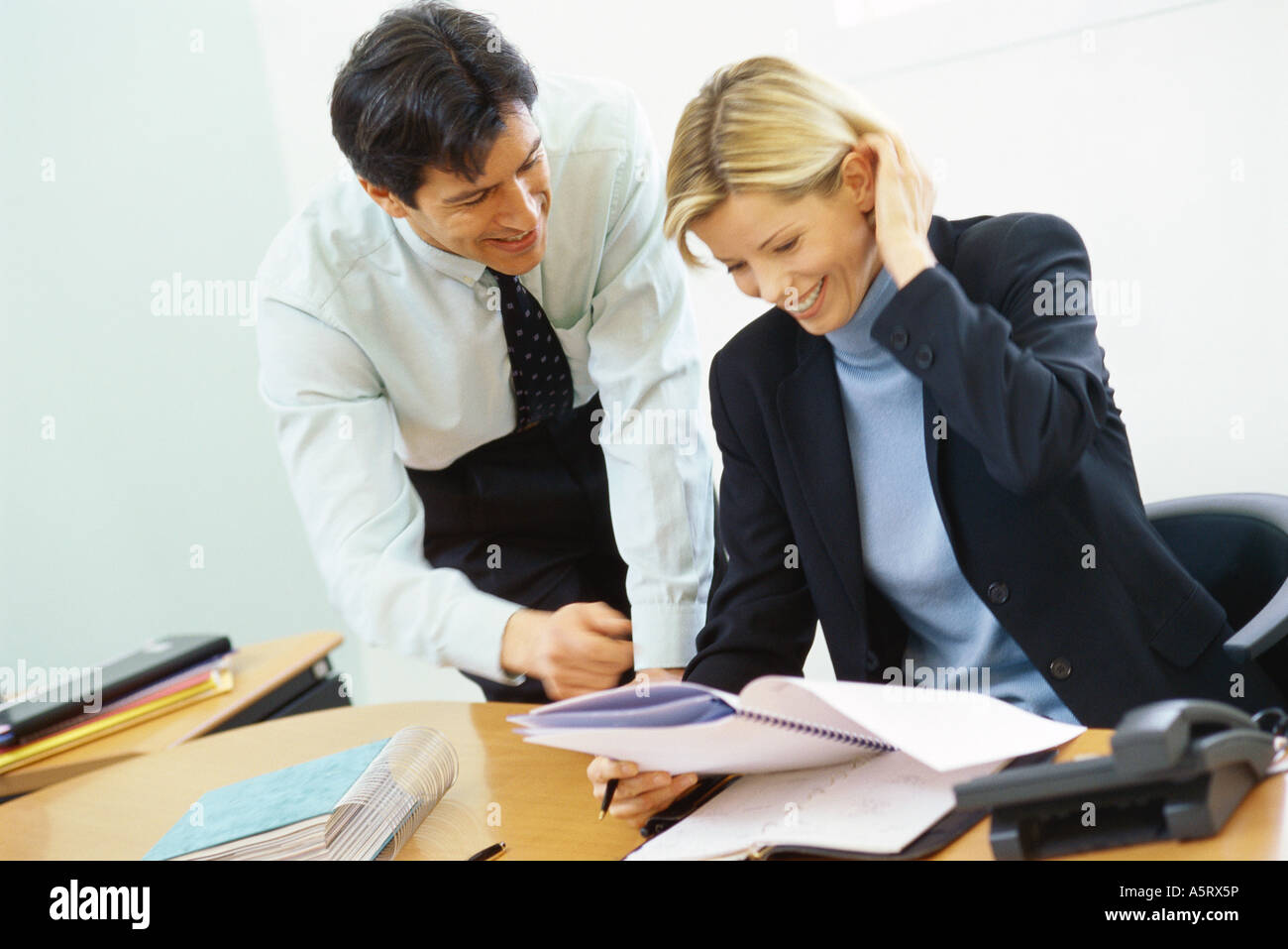 An adult woman leaning down to praise her hi-res stock photography and ...