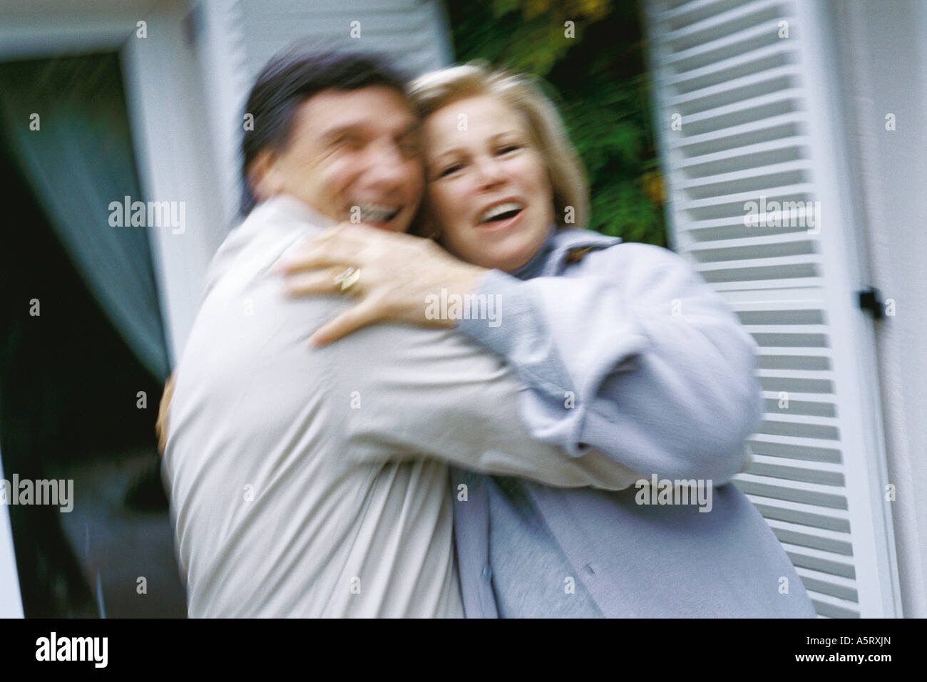 Mature couple hugging, blurred motion Stock Photo - Alamy