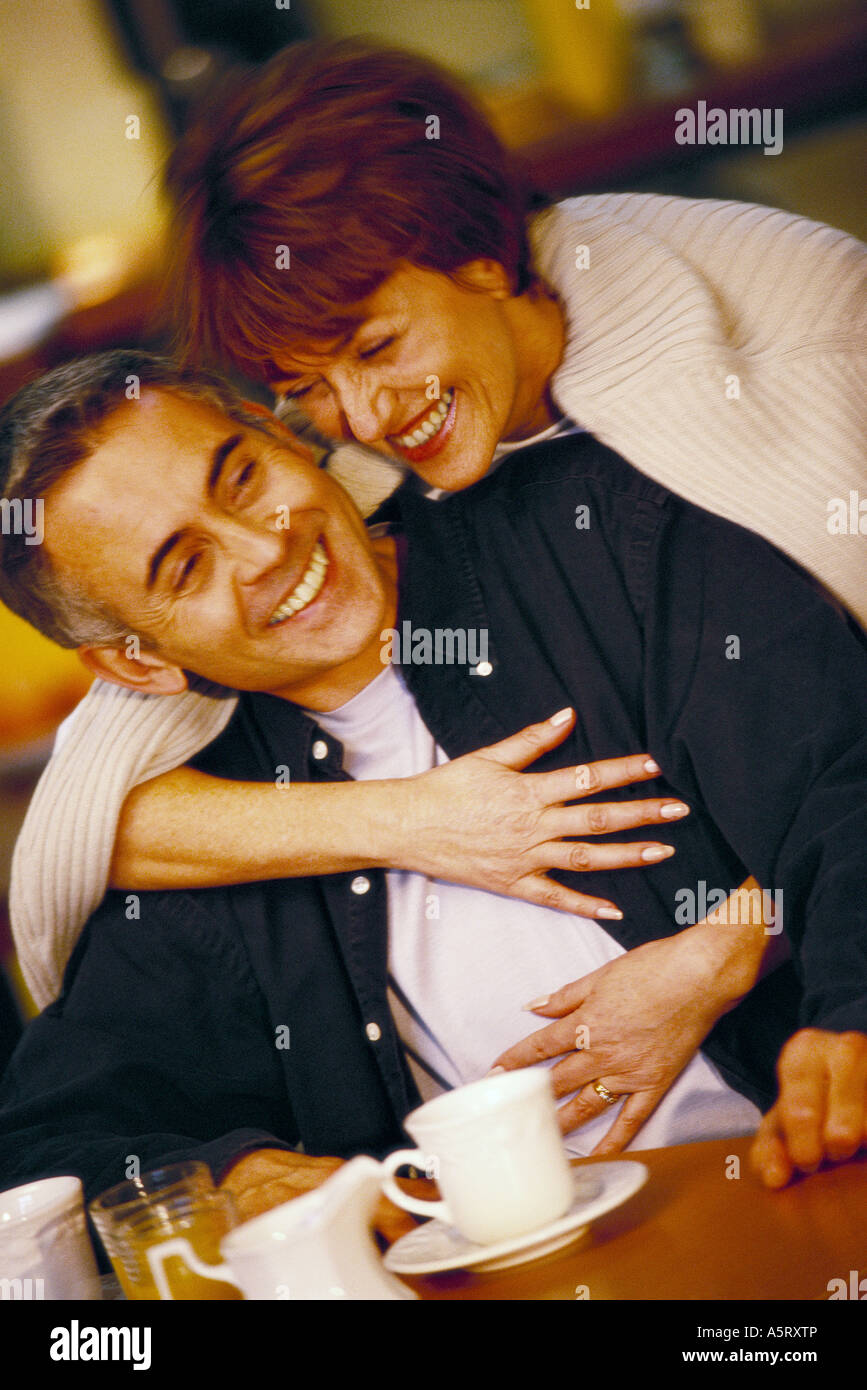 Couple hugging from behind laughing hi-res stock photography and images ...