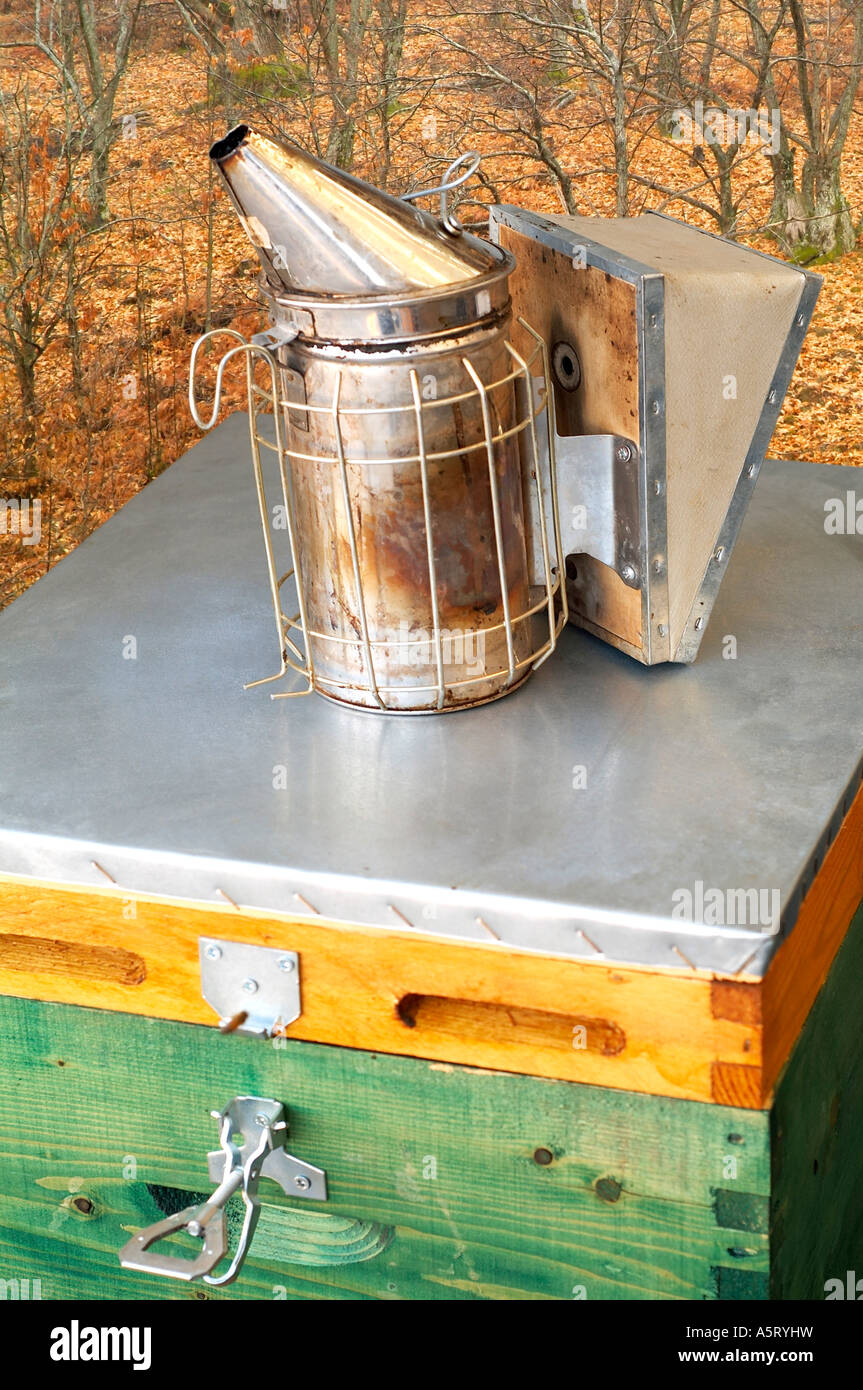 Bee hive and a smoker on top of it Stock Photo - Alamy