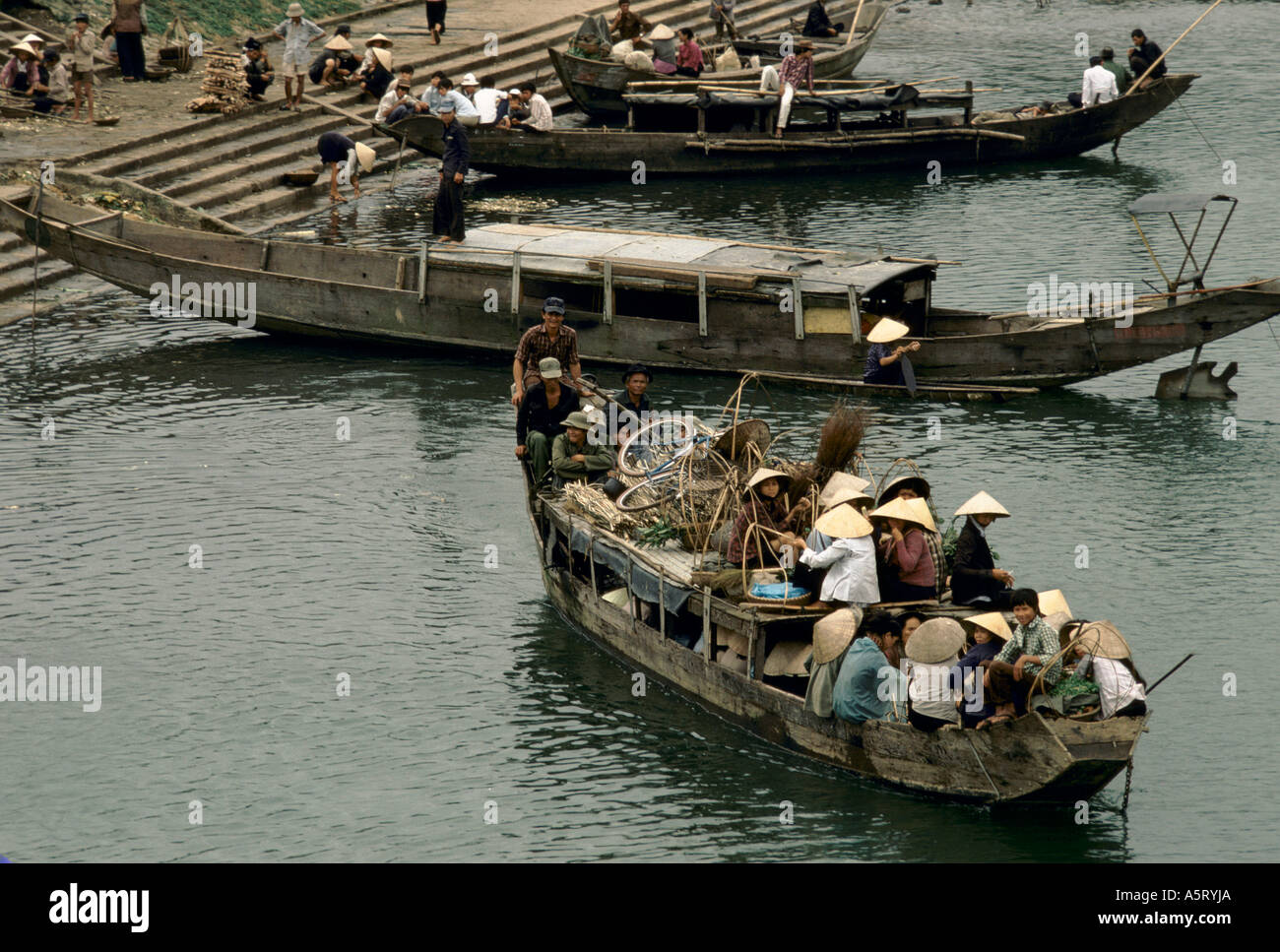VIETNAM, TRADITIONAL VIETNAMESE LONG BOATS CARRYING LOCALS IN CONICAL ...