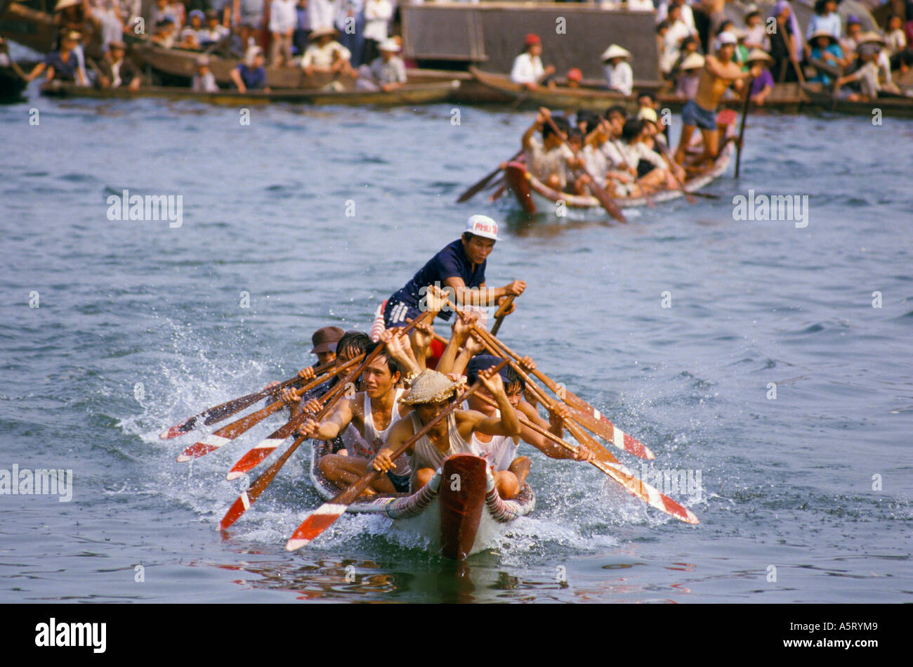 VIETNAM, CREW MEMBERS OF A DRAGON BOAT ROWING HARD TO WIN THE ...