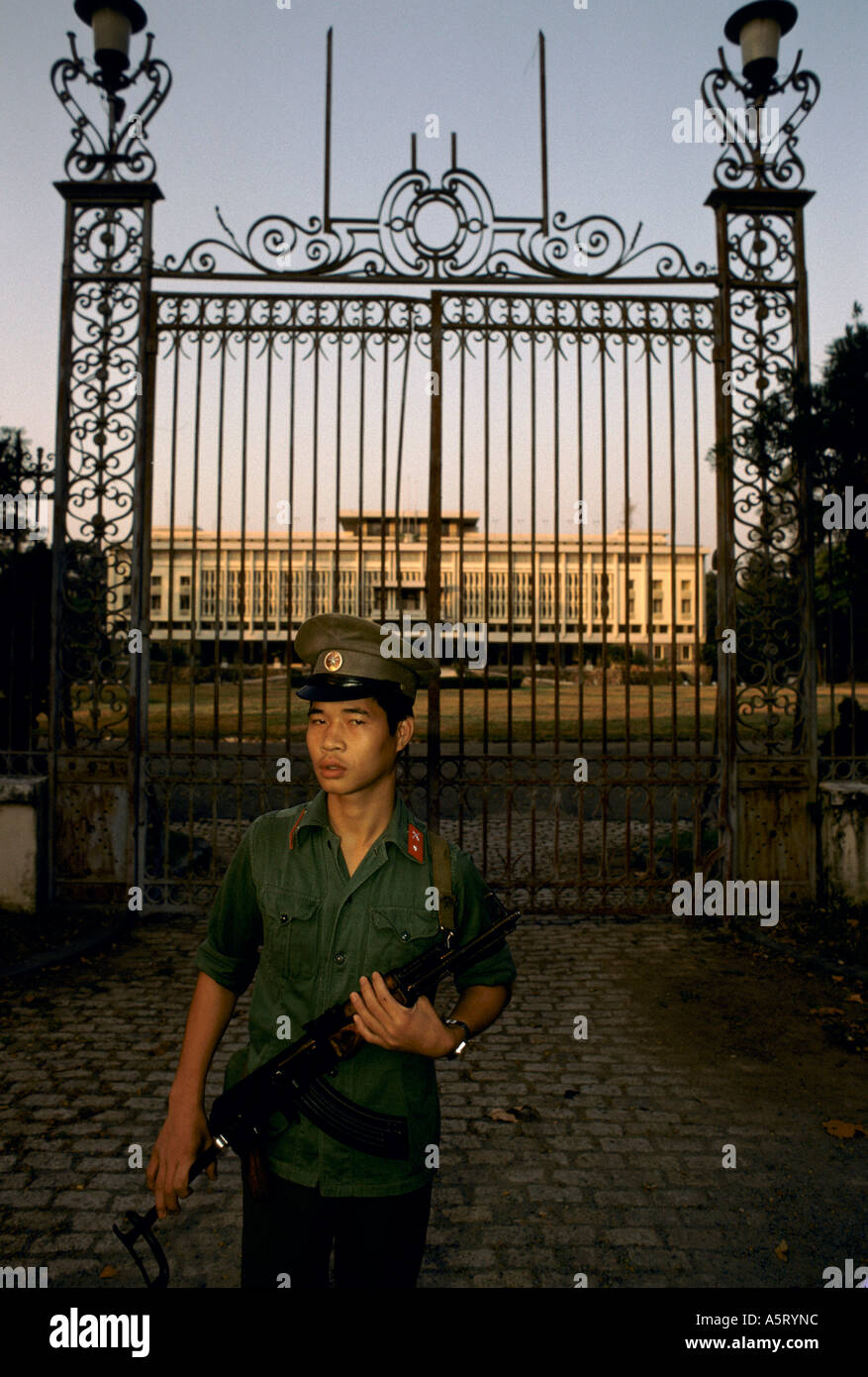 VIETNAM, AN ARMED GUARD STANDING OUTSIDE THE GATE OF HALL OF ...