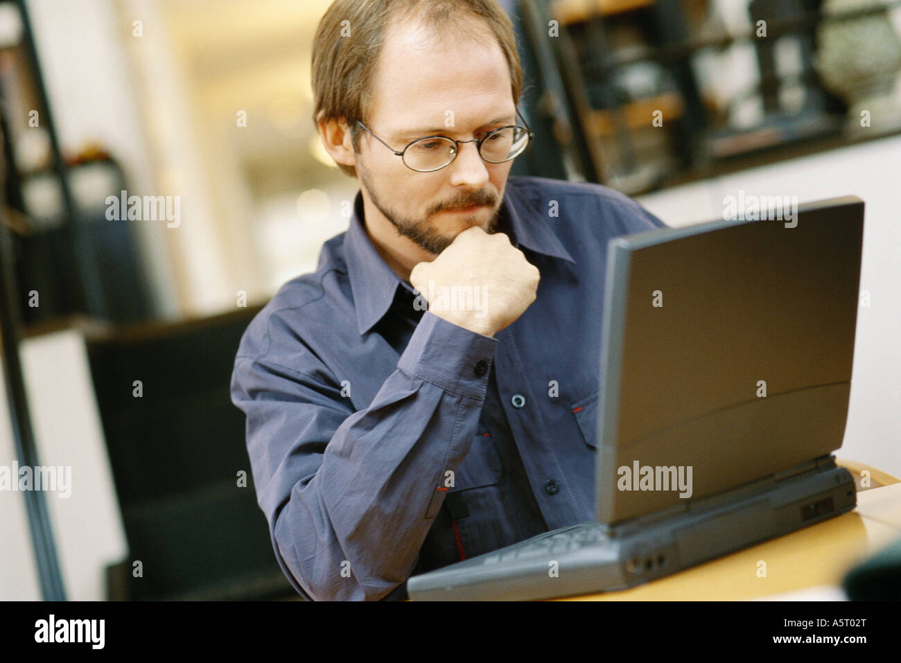 Man beard uses laptop sitting hi-res stock photography and images - Alamy