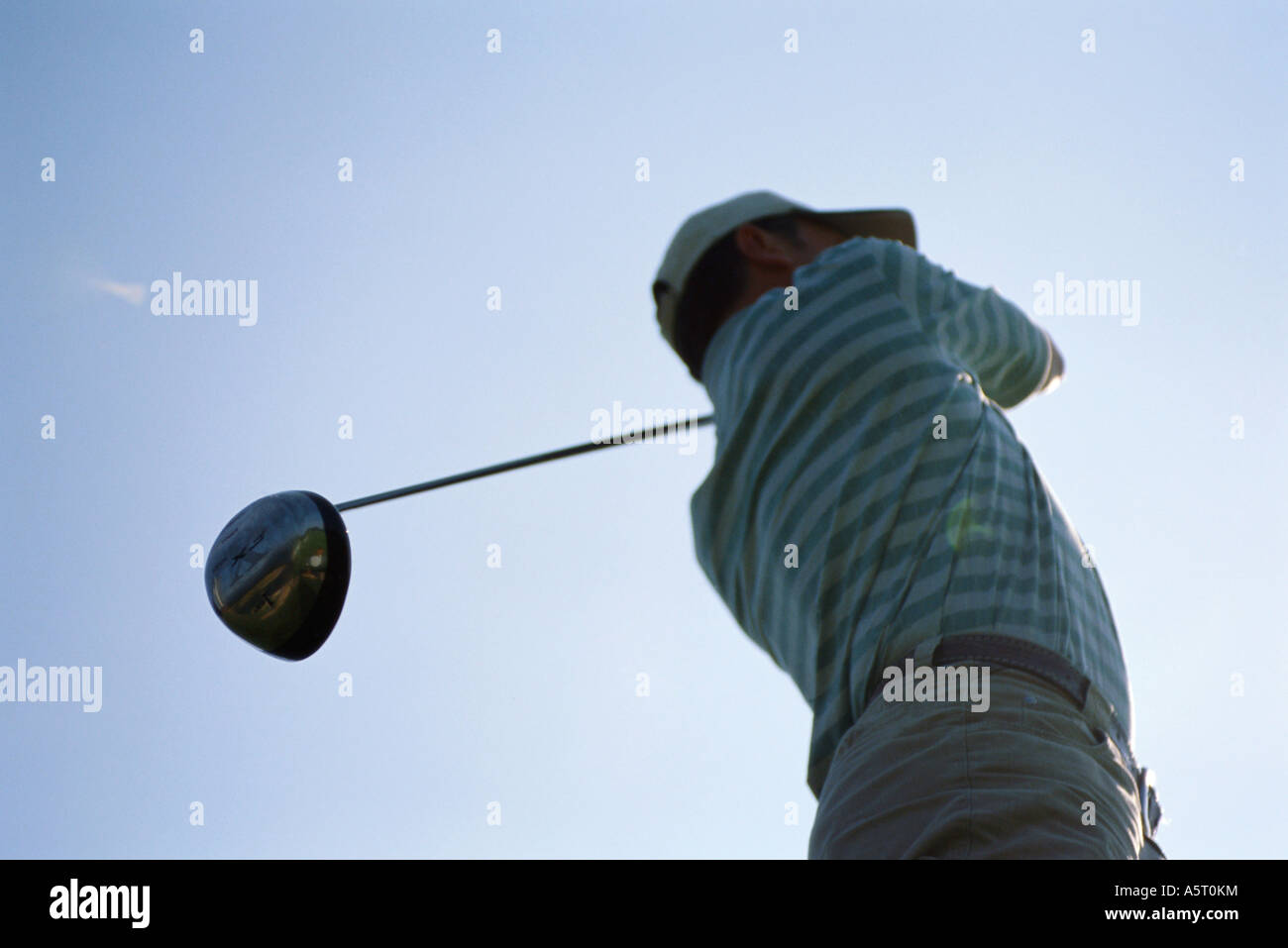Golfer with golf club over shoulder, low angle view Stock Photo - Alamy