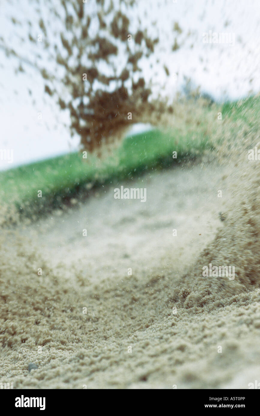 Sand flying in sand trap, close-up Stock Photo - Alamy