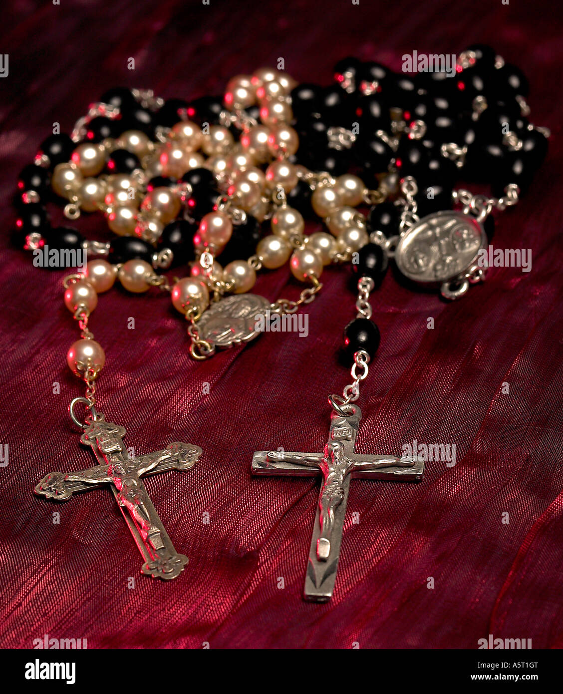 Two Rosaries on a red background Stock Photo - Alamy