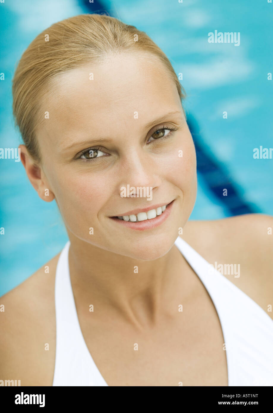 Young woman smiling, portrait, pool in background Stock Photo - Alamy