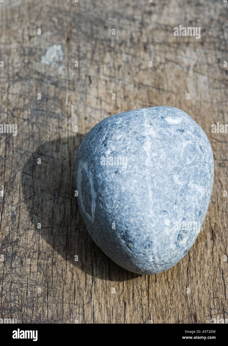Stone on wood surface Stock Photo - Alamy