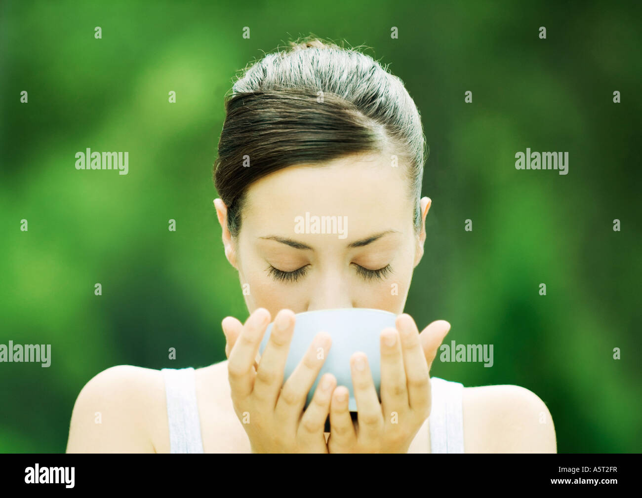 Woman drinking out of bowl Stock Photo - Alamy
