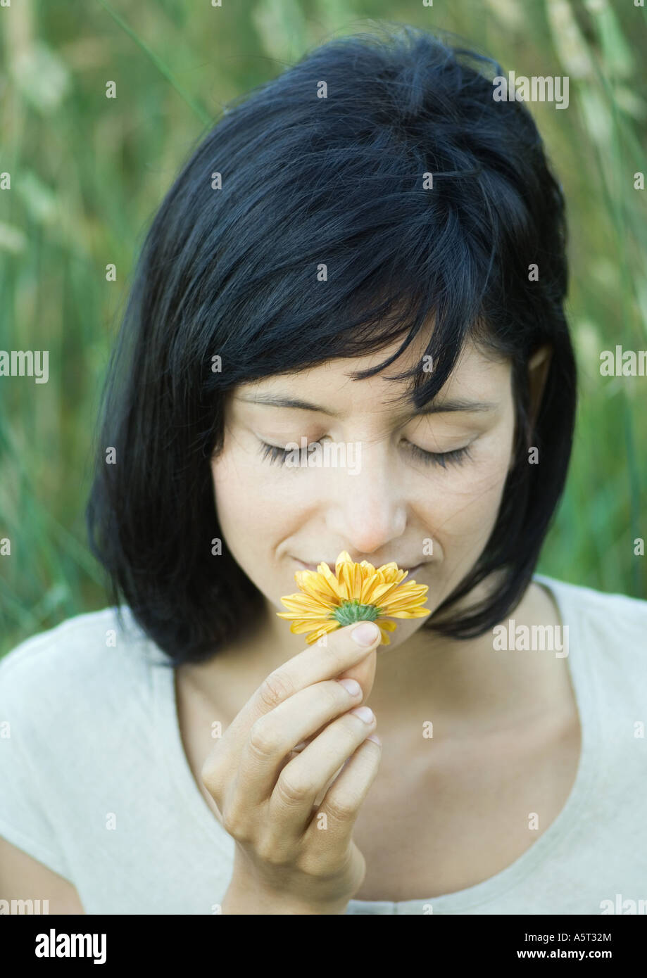 Woman smelling flower Stock Photo - Alamy
