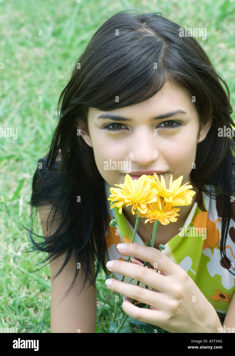 Woman smelling flowers Stock Photo - Alamy