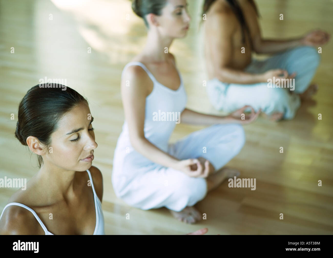 Woman sitting indian style meditating hi-res stock photography and ...