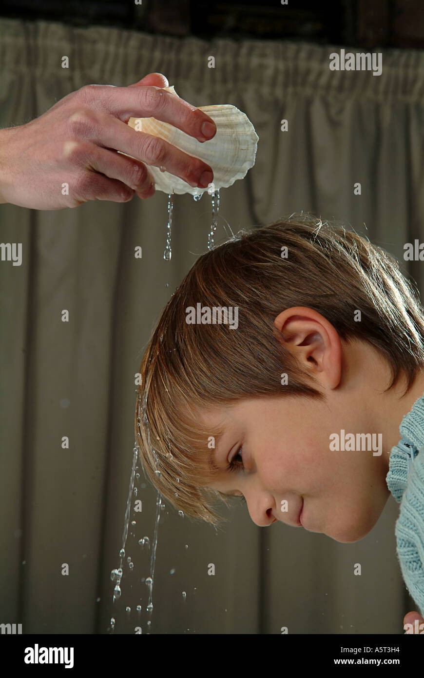 Christian baptism Sacrament, anointing a child’s head with holy water ...