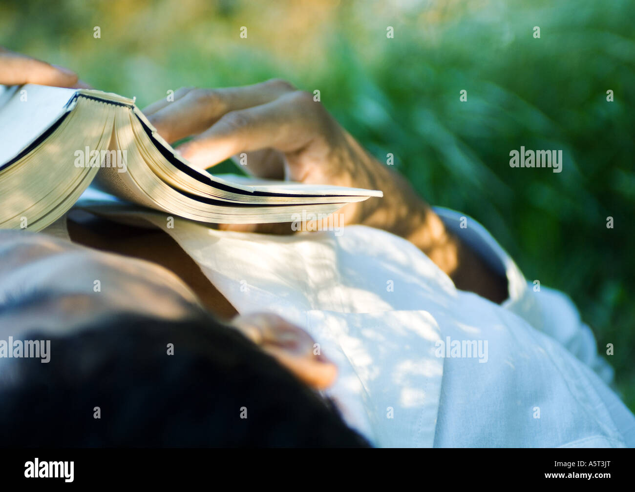 Book on his chest hi-res stock photography and images - Alamy